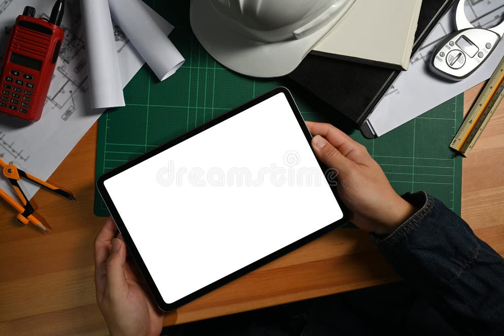 Engineer Man Using Digital Tablet and Working with Blueprints at ...