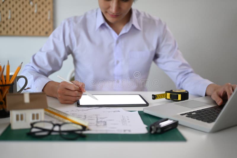 Engineer Using Digital Tablet and Working with Drawings Inspection at ...