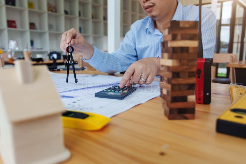 Engineer Man Working in the Office, Drawing the Construction Project ...