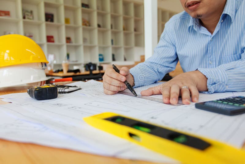 Engineer Man Working in the Office, Drawing the Construction Project ...