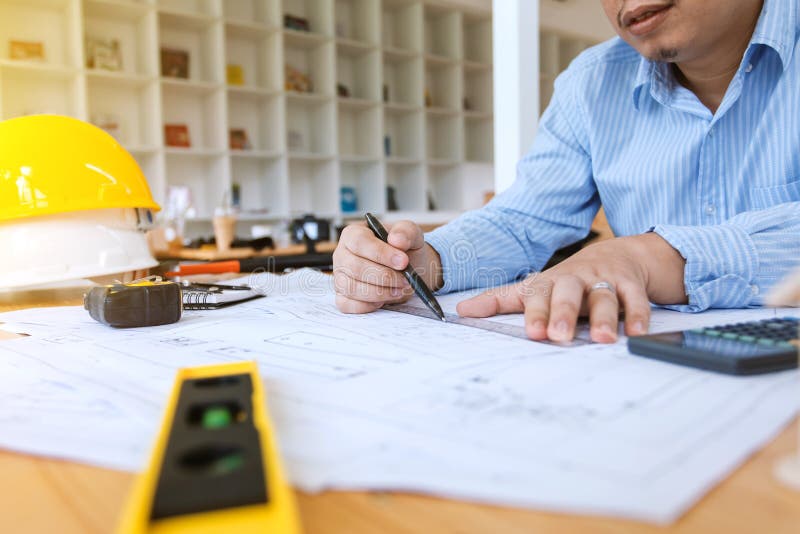 Engineer Man Working in the Office, Drawing the Construction Project ...