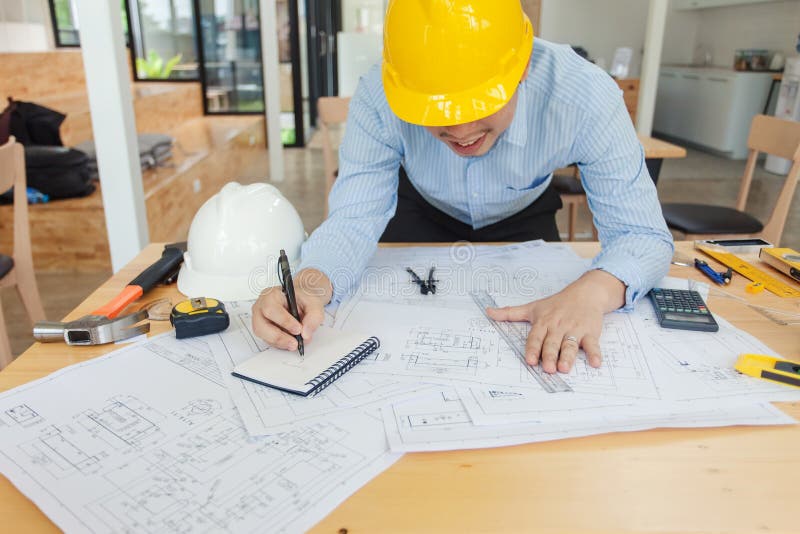 Engineer Man Working in the Office, Drawing the Construction Project ...