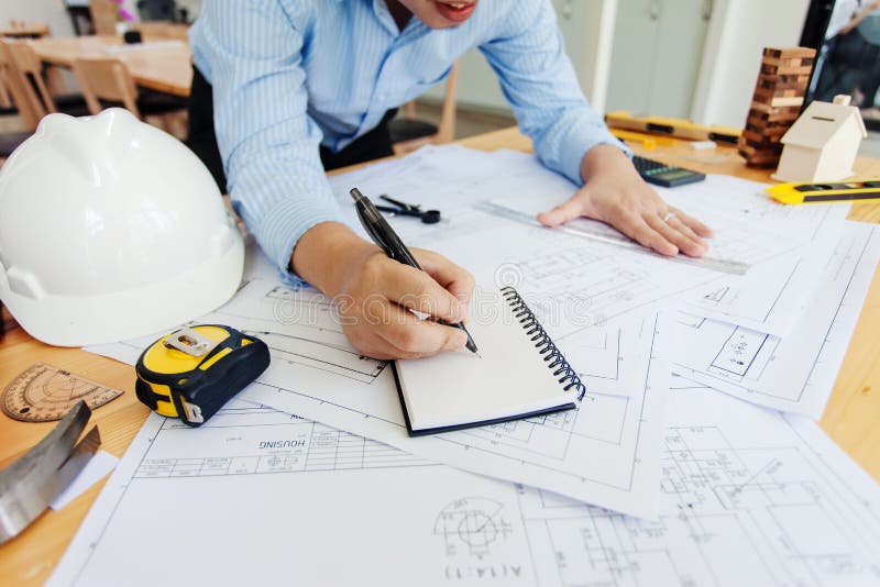 Engineer Man Working in the Office, Drawing the Construction Project ...