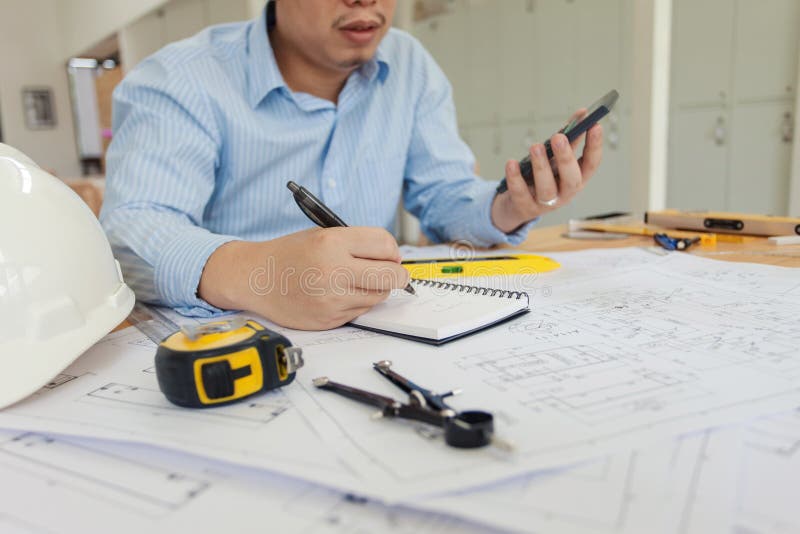 Engineer Man Working in the Office, Drawing the Construction Project ...