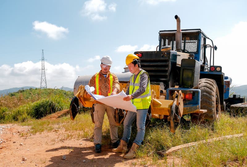 Engineer Manager Discuss with His Team and Stand in Front of Tractor in ...