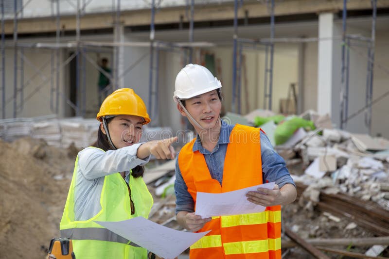 Engineer Manager Inspects Construction Sites and Checking Blueprints at ...