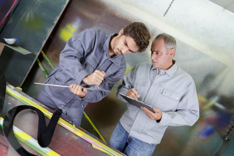 Engineer and Manager Working in Mechanic Storage Room Stock Photo ...