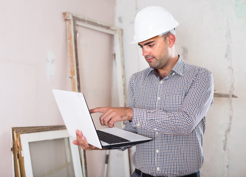 Engineer Managing Process with Laptop in Helmet Stock Photo - Image of ...
