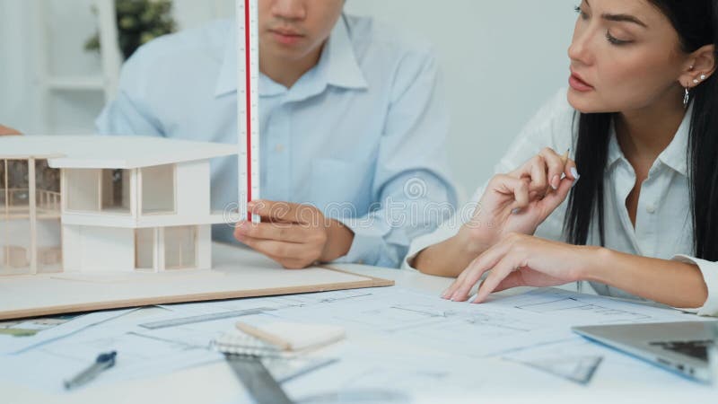 Engineer Measures Model while Skilled Designer Writes at Blueprint ...