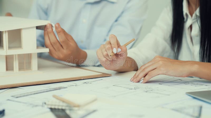 Engineer Measures Model while Skilled Designer Writes at Blueprint ...