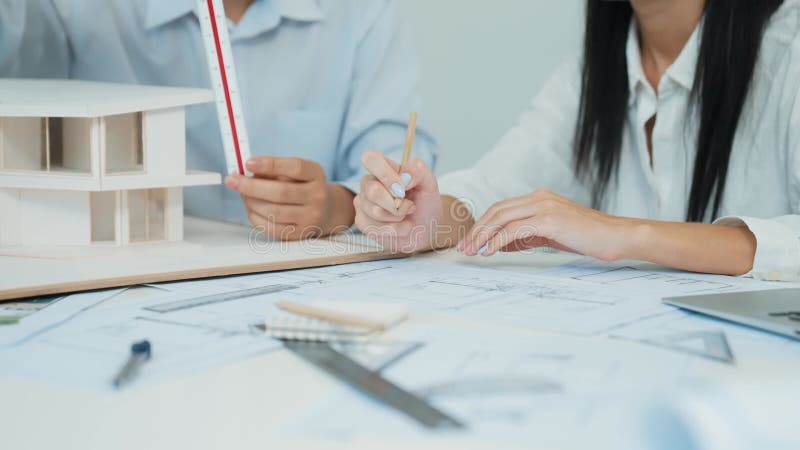 Engineer Measures Model while Skilled Designer Writes at Blueprint ...