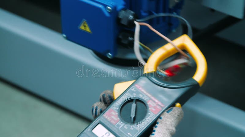 Engineer Measuring Technical Parameters of Industrial Machine with ...