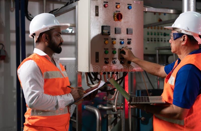 Engineer of a Mechanical Plant Inspecting and Explaining the ...