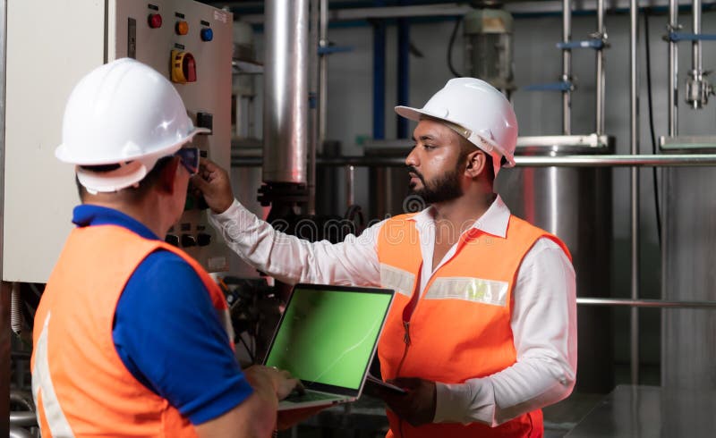 Engineer of a Mechanical Plant Inspecting and Explaining the ...
