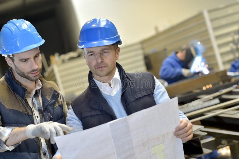 Engineer with Mechanical Worker in a Metallurgic Factory Stock Photo ...