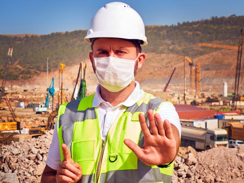 Engineer in Medical Mask Shows Stop Sign Standing Opposite Construction ...