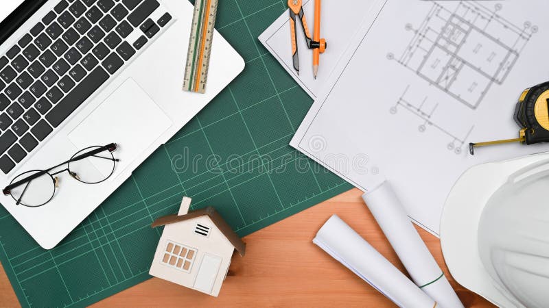 Engineer Office Desk with Laptop, Blueprints, Hard Hat and Engineering ...