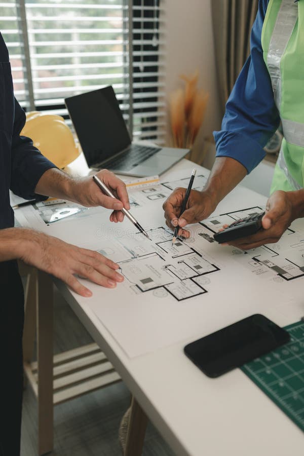 An Engineer is in the Office with His Assistant, they are Examining ...