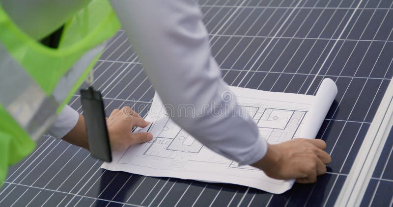 Engineer Open Blueprint of Solar Farm Project on Solar Cells Panel ...