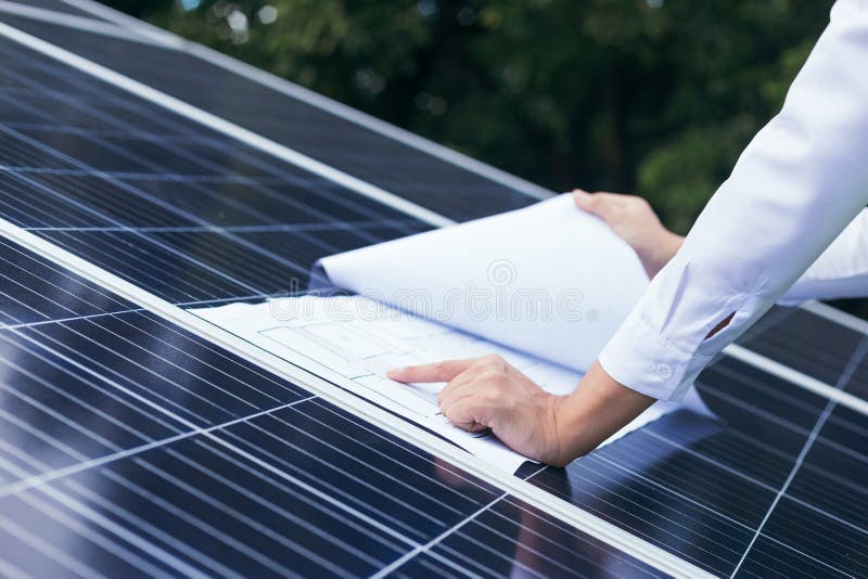 Engineer Open Blueprint of Solar Farm Project on Solar Cells Panel ...