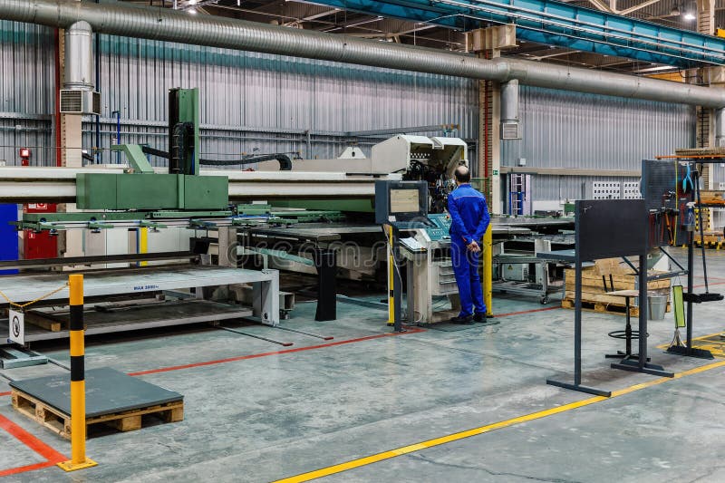 Engineer Operates CNC Perforation Machine Stock Photo - Image of ...