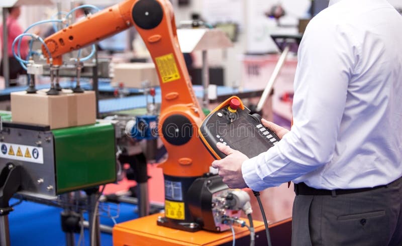 Engineer Operating Advanced Robotic Arm in an Automated Industrial ...