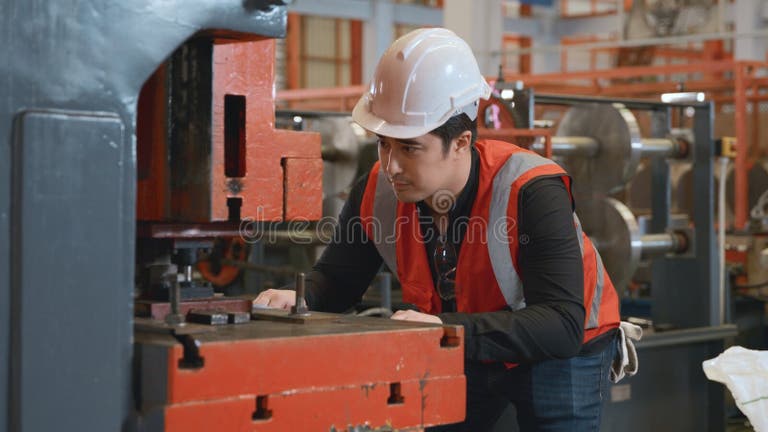 Engineer or Operator Wearing a Safety Suit Working Bending Metal Sheet ...