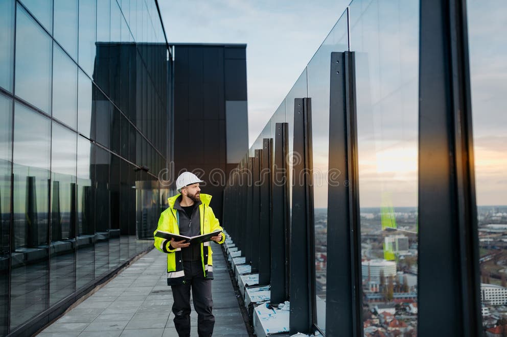 Engineer Overseeing City Construction Project with Blueprints in Hand ...