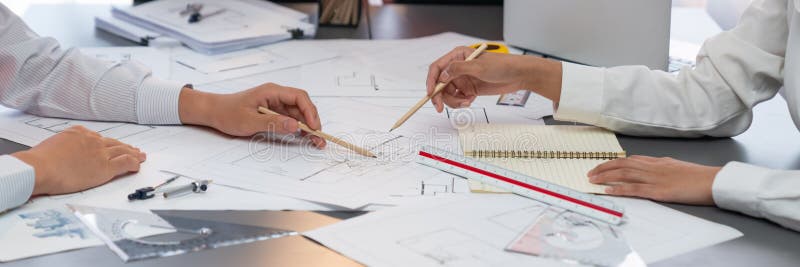 Engineer Partner Drawing and Working on Blueprint Design Together ...