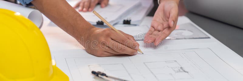 Engineer Partner Drawing and Working on Blueprint Design Together ...