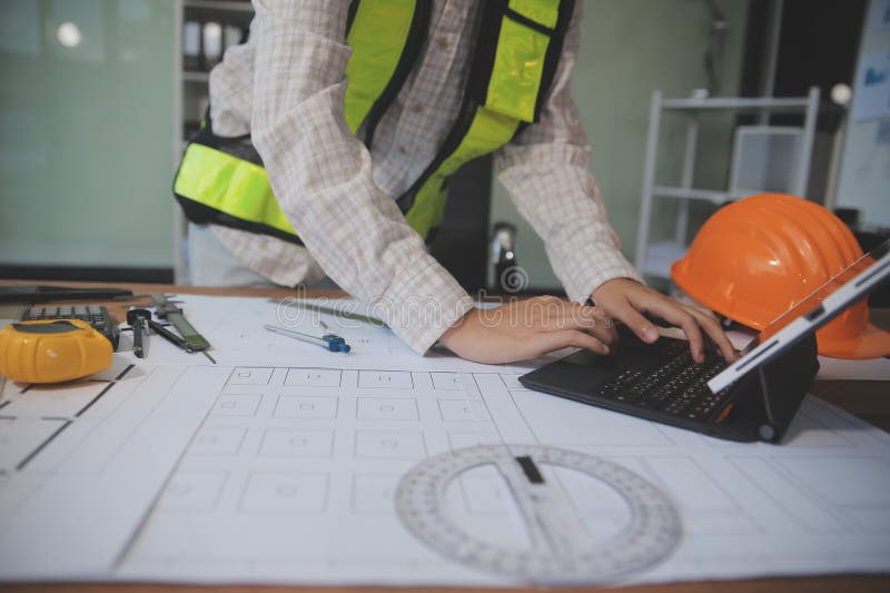 Engineer People Meeting Working and Pointing at a Blueprint in Office ...