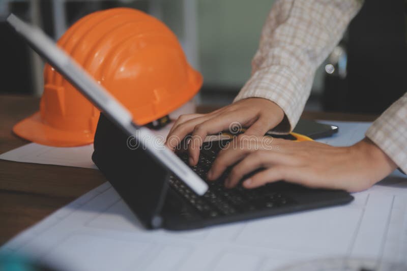 Engineer People Meeting Working and Pointing at a Blueprint in Office ...