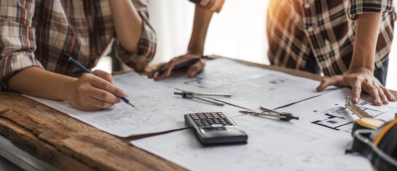 Engineer People Meeting Working and Pointing at a Drawings in Office ...