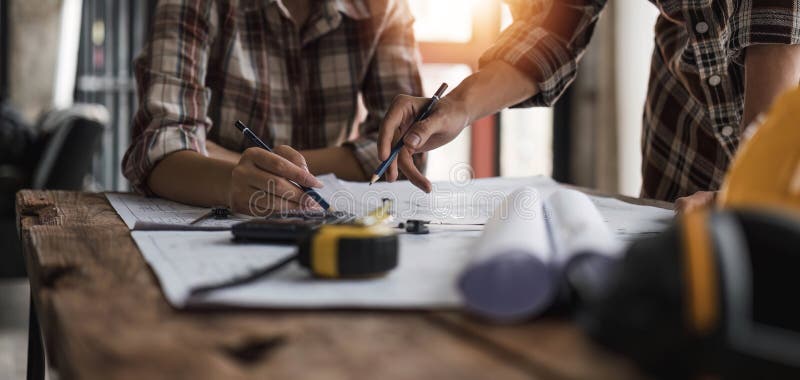 Engineer People Meeting Working and Pointing at a Drawings in Office ...