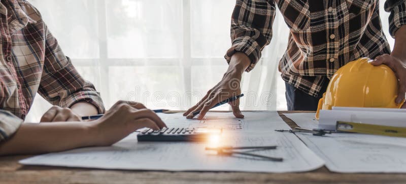 Engineer People Meeting Working and Pointing at a Drawings in Office ...