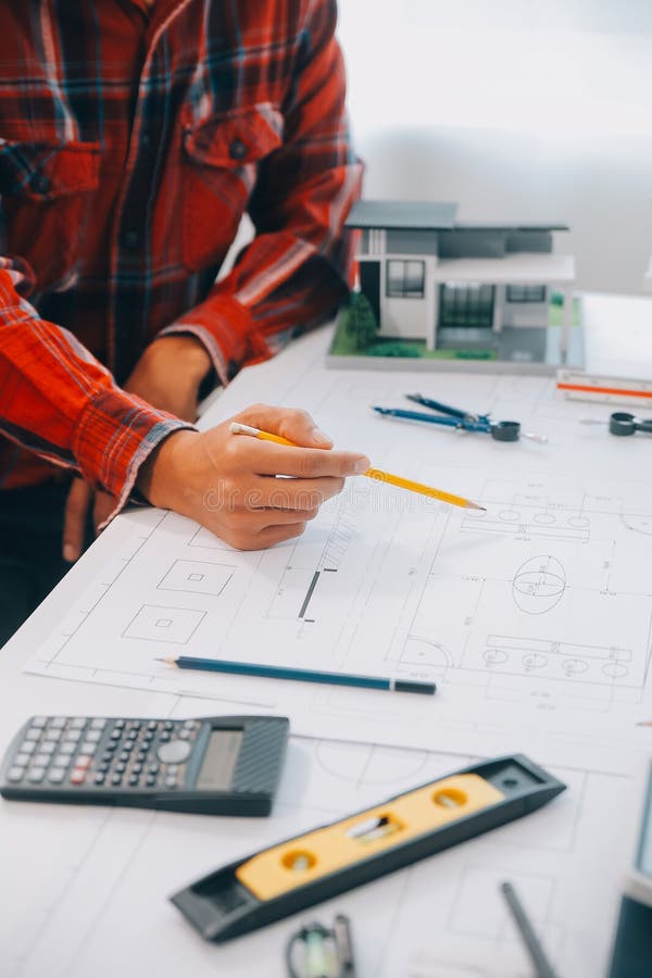 Engineer People Meeting Working and Pointing at a Drawings in Office ...