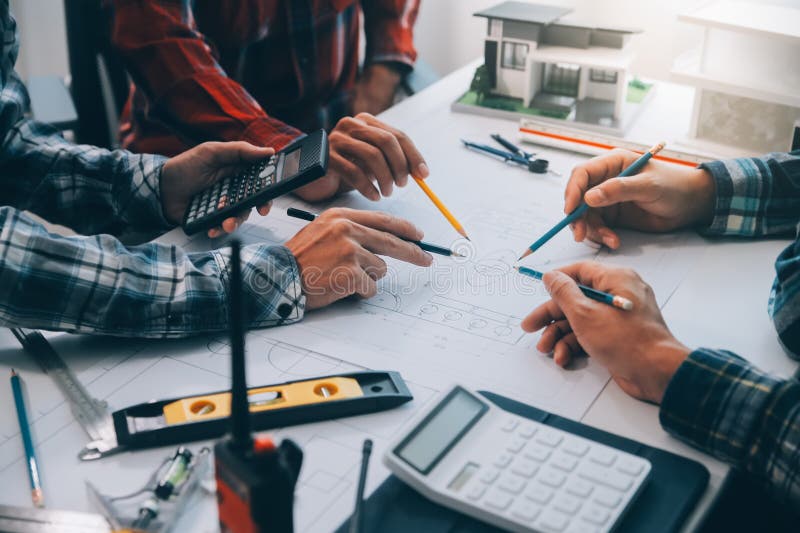 Engineer People Meeting Working and Pointing at a Drawings in Office ...