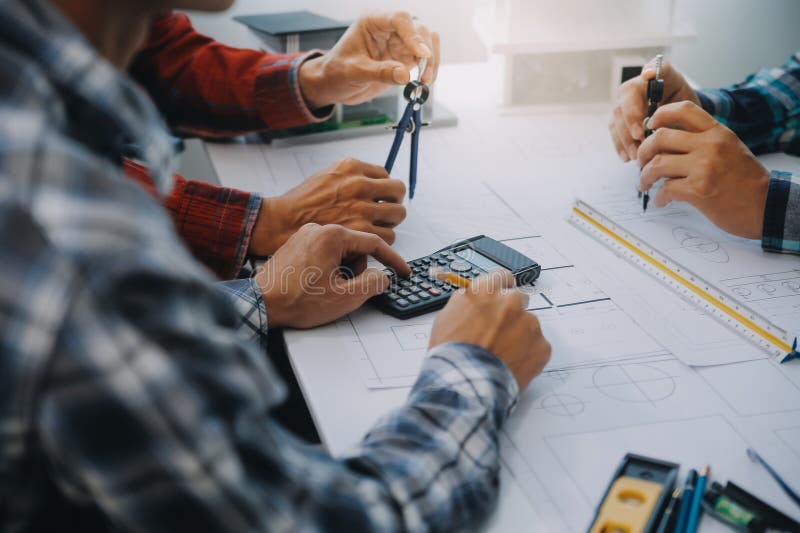 Engineer People Meeting Working and Pointing at a Drawings in Office ...