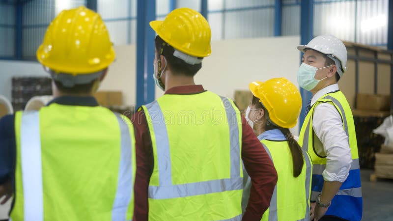 Engineer People are Putting a Protective Helmet on Head in Warehouse ...
