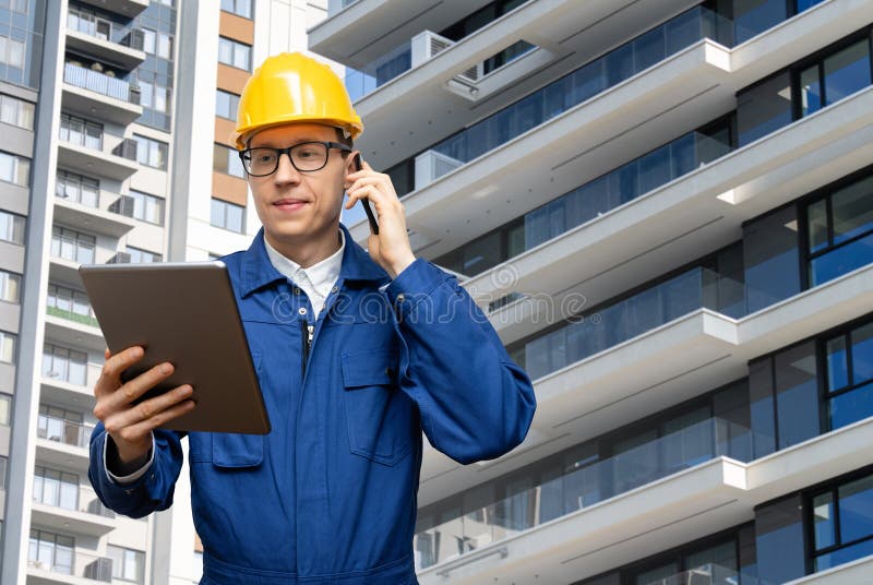 Engineer with Digital Tablet on a Background of Power Line Tower. Stock ...