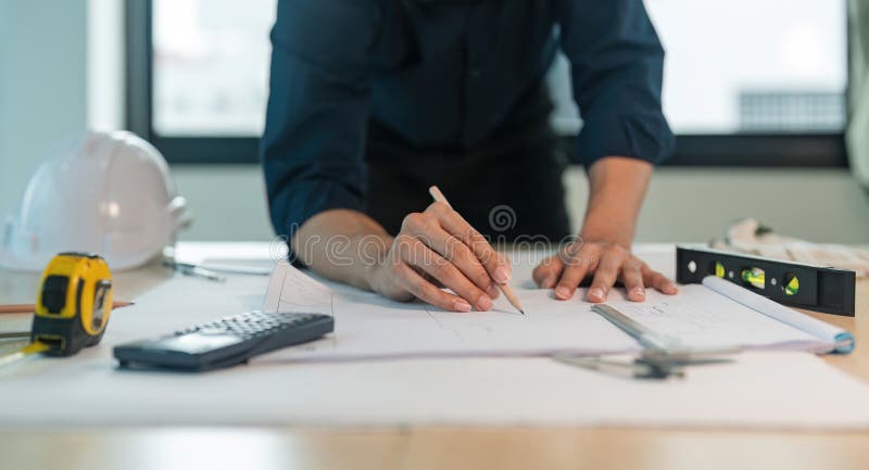 Engineer Planing and Working on Table Construction Working at Office ...