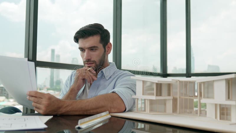 Engineer Planning House Construction while Looking at House Model ...
