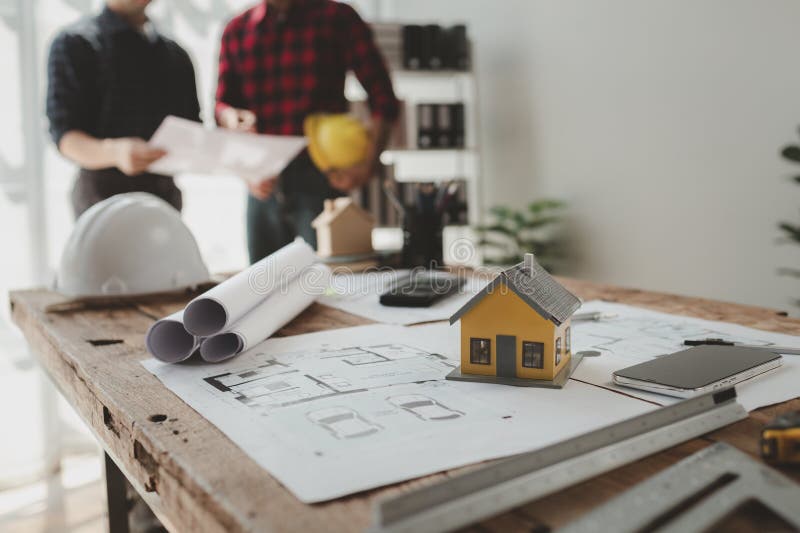 A Building and House Architect is Reviewing and Revising the House ...