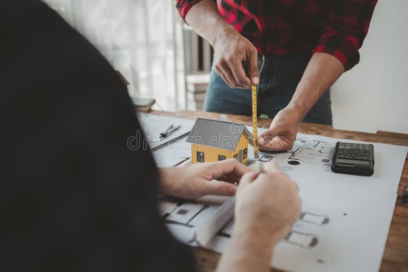 A Building and House Architect is Reviewing and Revising the House ...