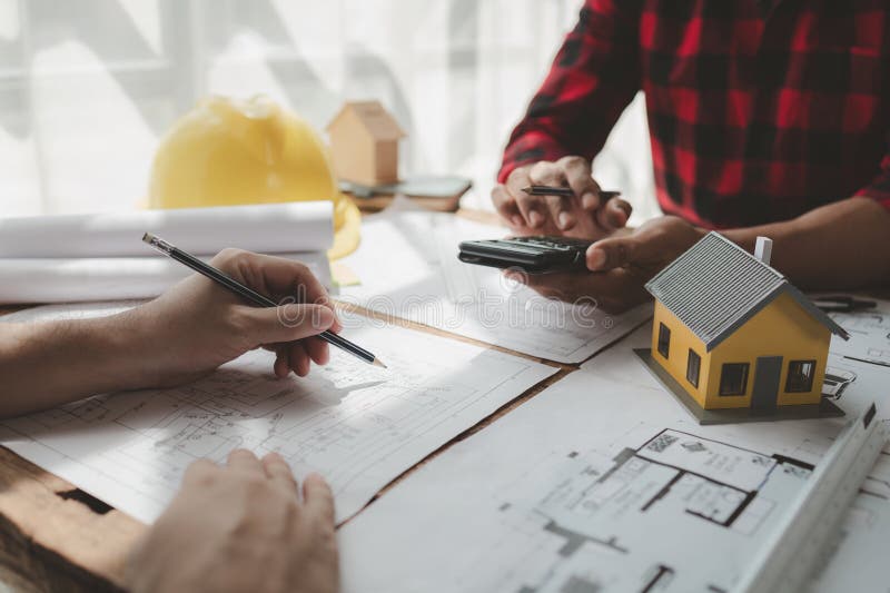 A Building and House Architect is Reviewing and Revising the House ...