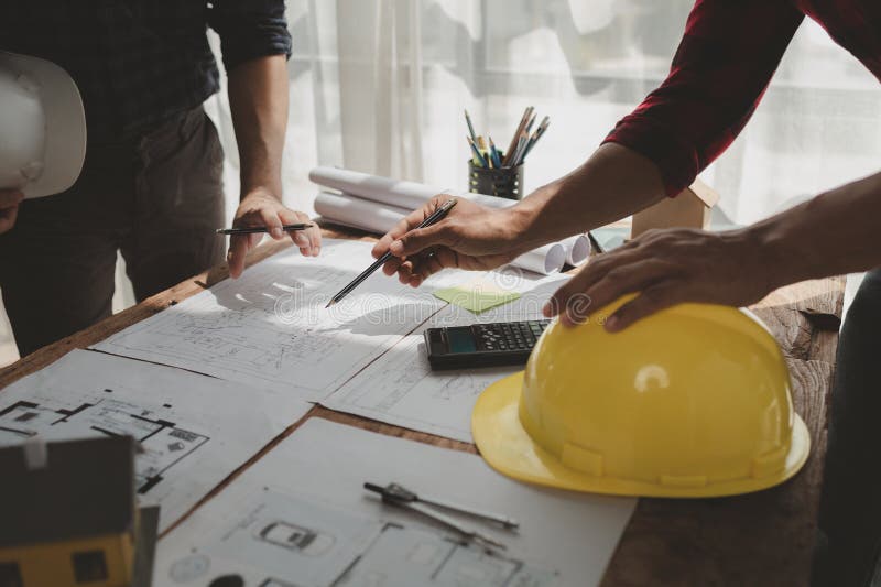 A Building and House Architect is Reviewing and Revising the House ...