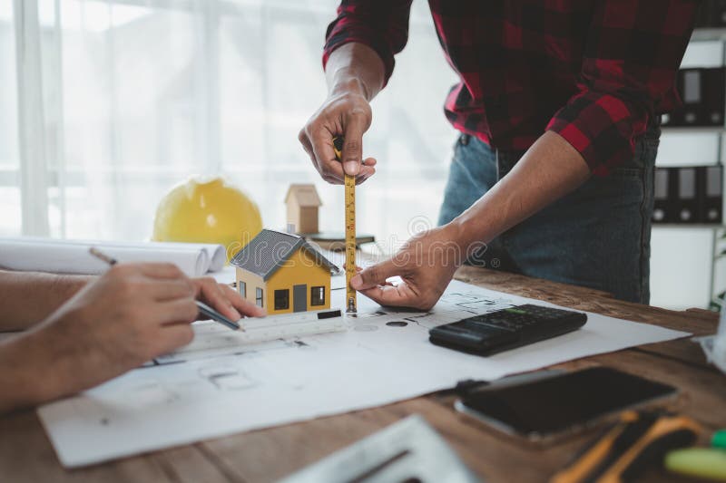 A Building and House Architect is Reviewing and Revising the House ...