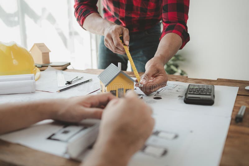 A Building and House Architect is Reviewing and Revising the House ...