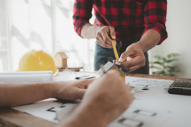 A Building and House Architect is Reviewing and Revising the House ...