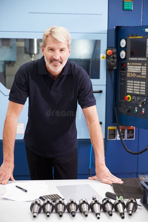 Engineer Planning Project with CNC Machinery in Background Stock Photo ...